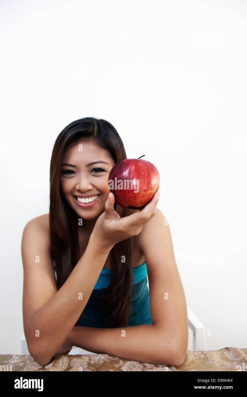Studio portrait of young woman holding apple Stock Photo - Alamy