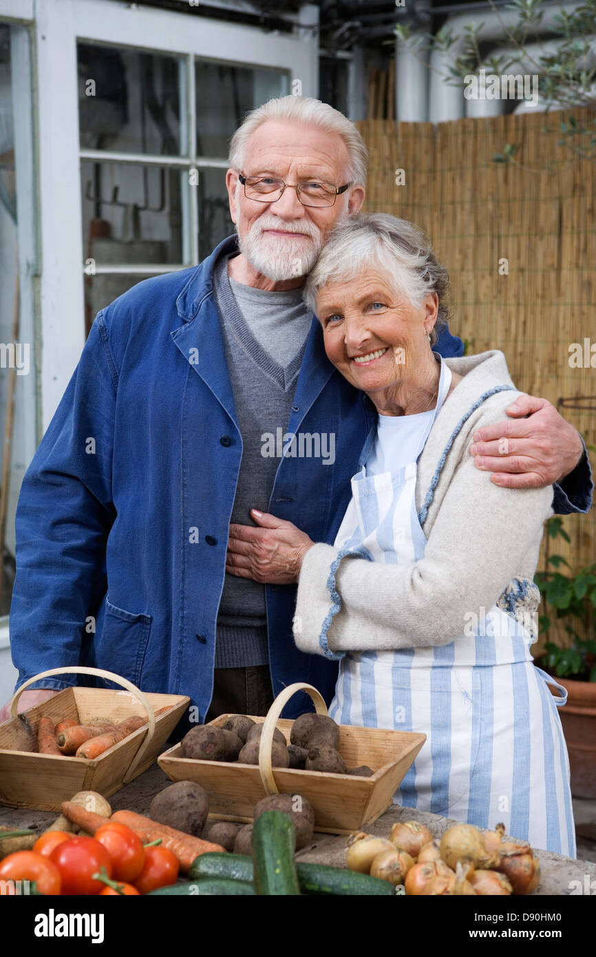 An elderly scandinavian couple with vegetables in front of them, Sweden ...