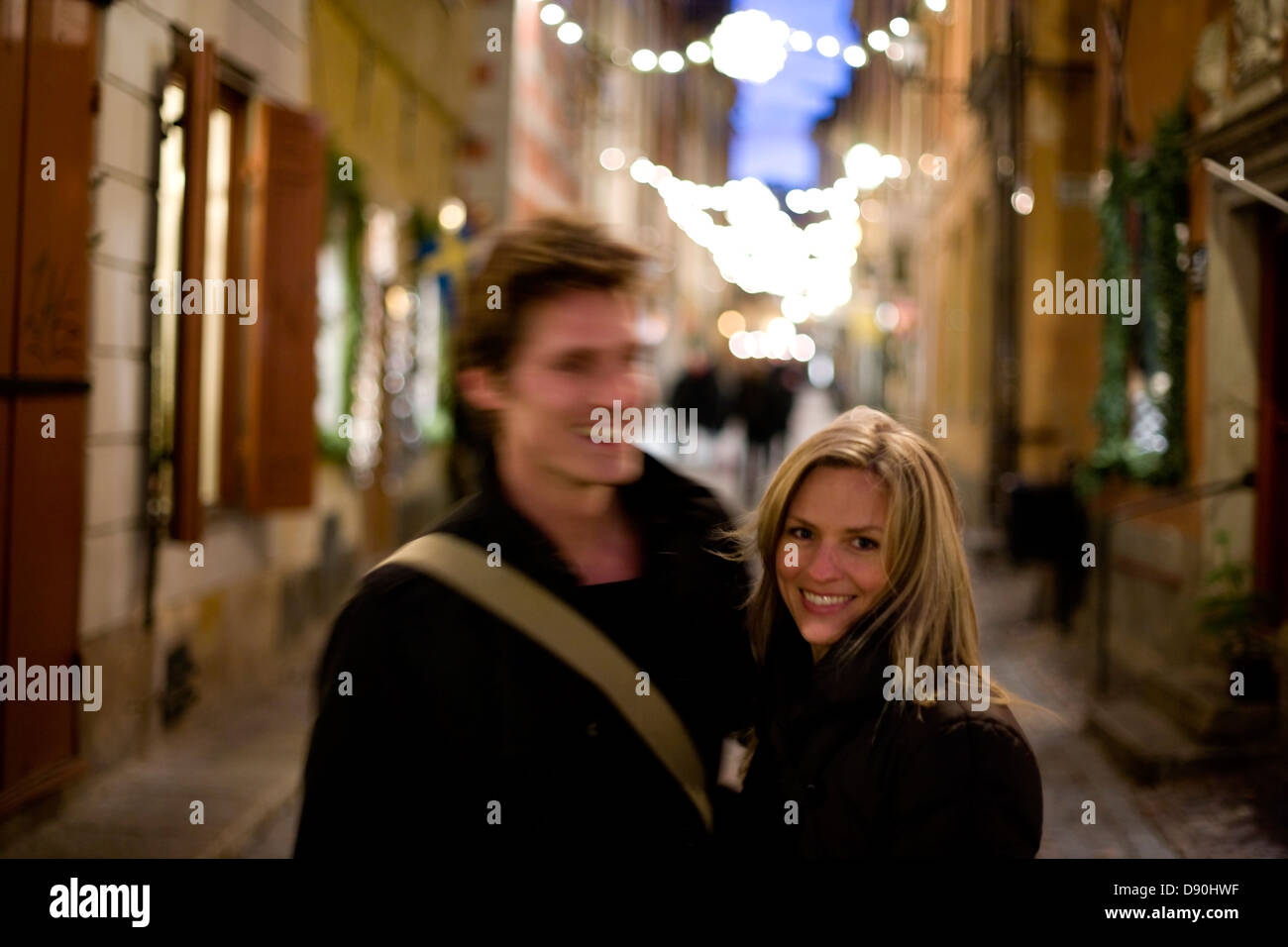 Couple walking on street at night Stock Photo - Alamy
