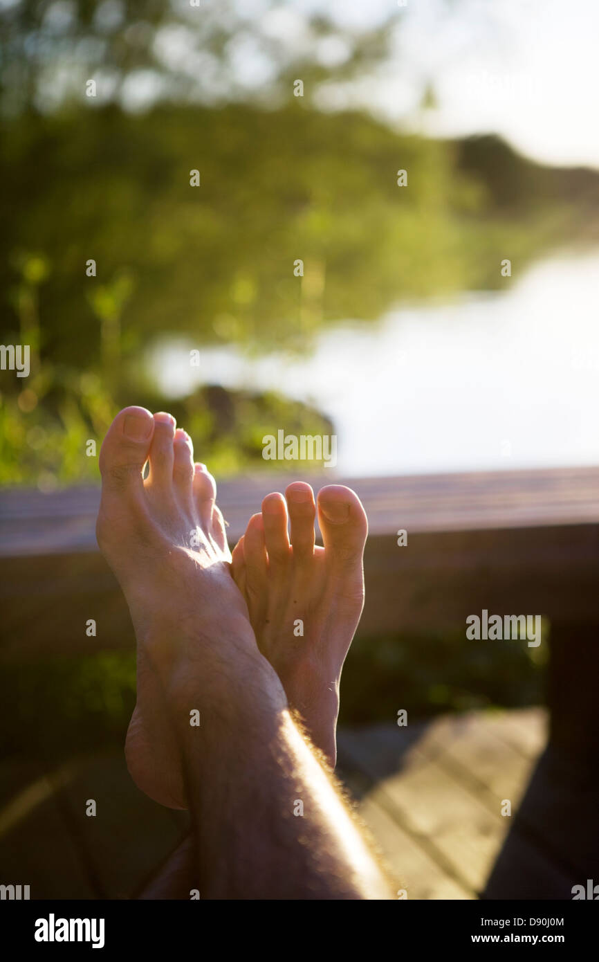 Barefoot man resting, Mariefred, Sweden Stock Photo - Alamy