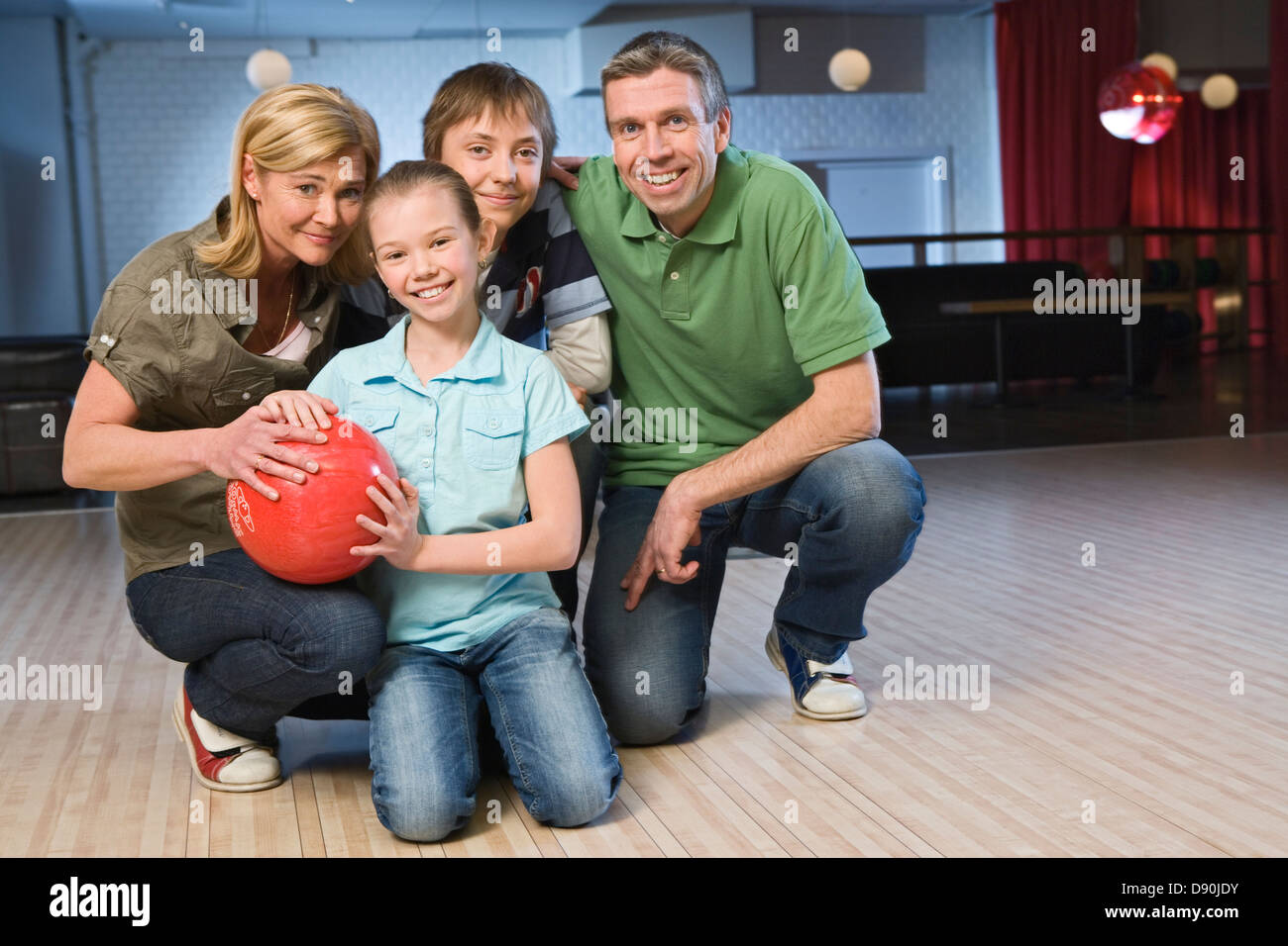 A family in a bowling alley Stock Photo - Alamy
