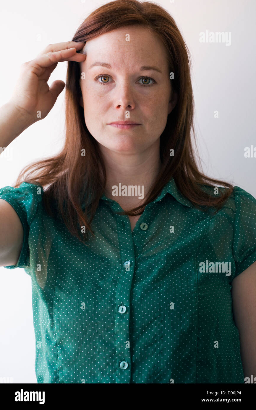 Woman standing against white background Stock Photo - Alamy