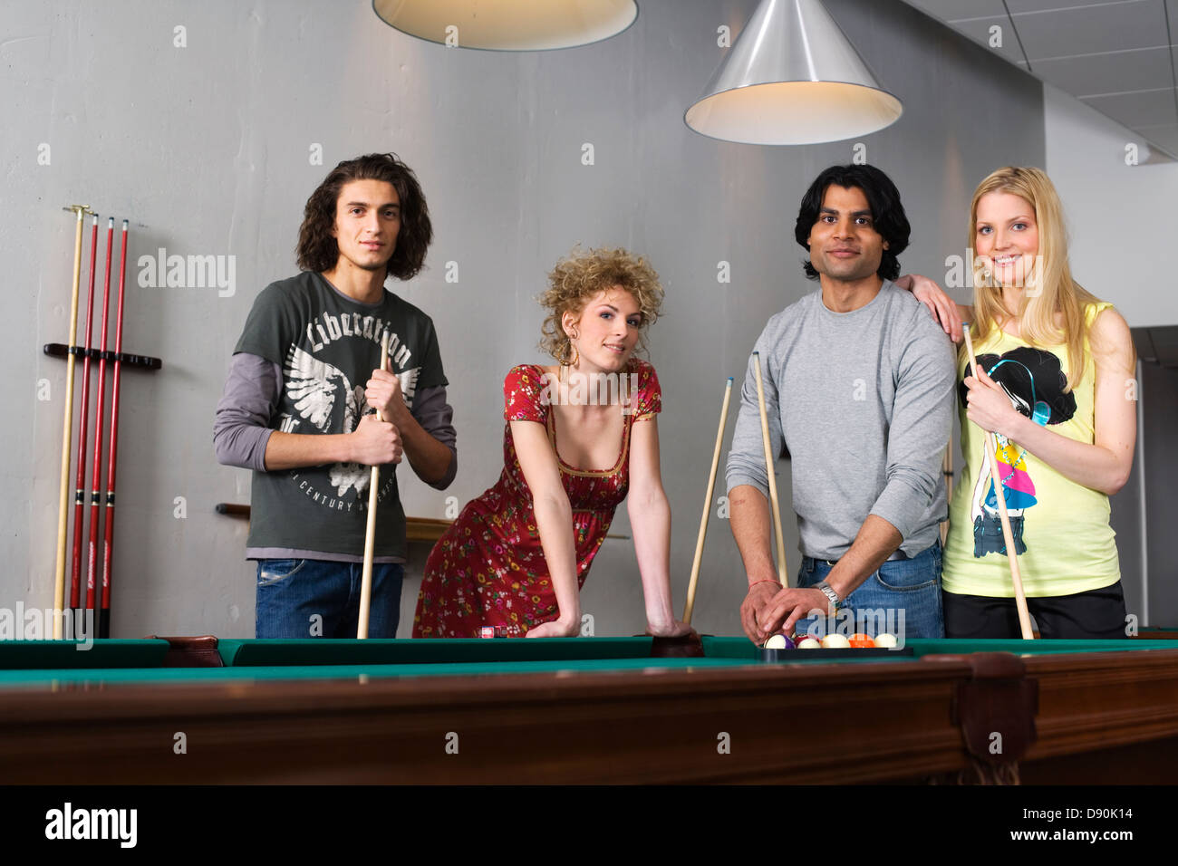 Four people standing pool table hi-res stock photography and images - Alamy
