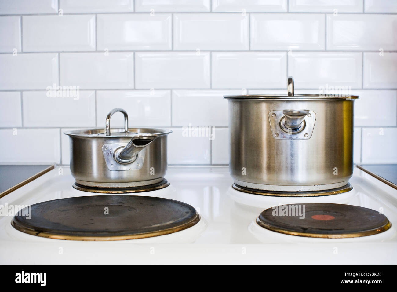Two pans on stove Stock Photo - Alamy