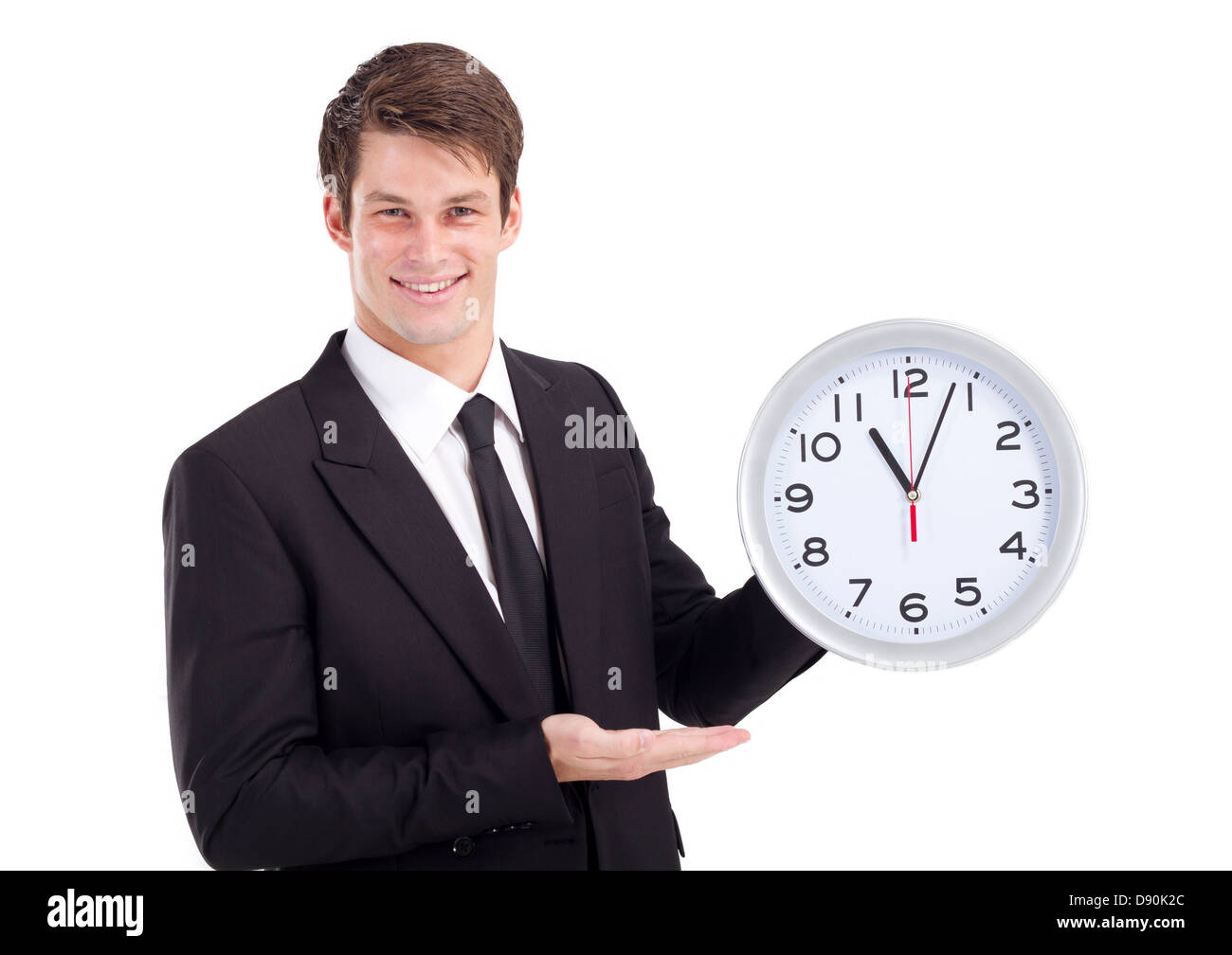 young businessman holding clock over white Stock Photo - Alamy