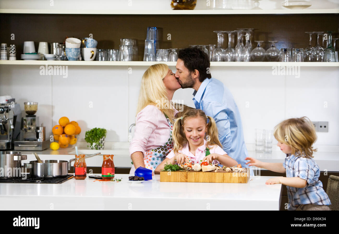 A family cooking dinner together Stock Photo - Alamy