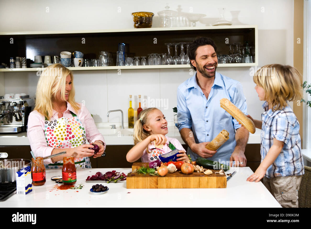A family cooking dinner together Stock Photo - Alamy