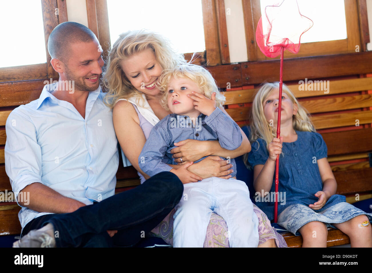 Parents sitting with children, smiling Stock Photo - Alamy
