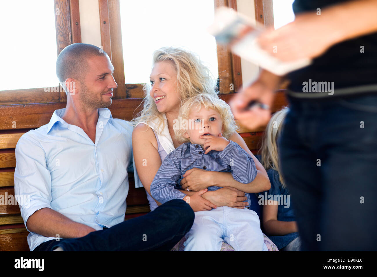 Parents sitting with children, smiling Stock Photo - Alamy