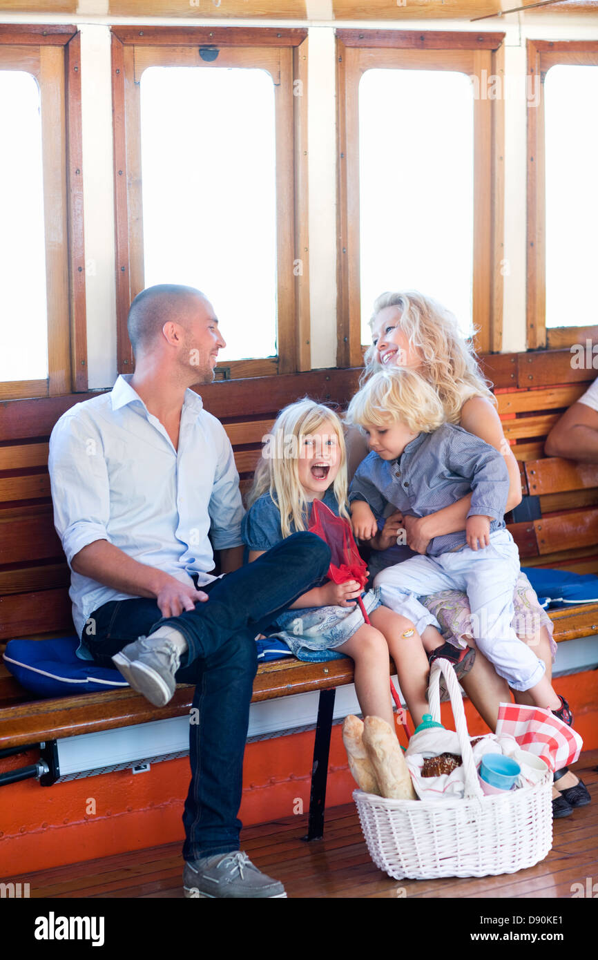 Parents sitting with children, smiling Stock Photo - Alamy