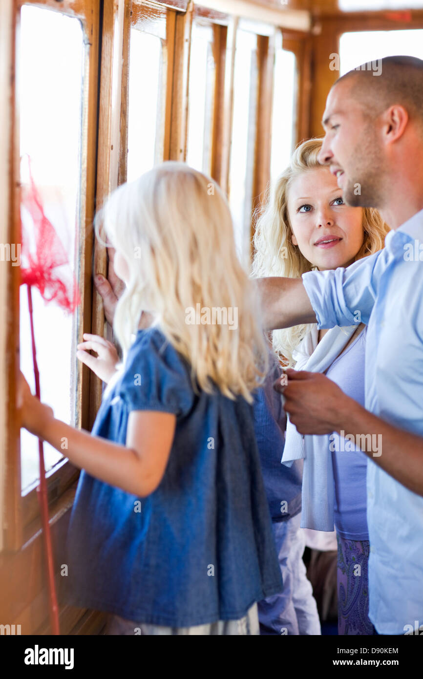 Family looking through window Stock Photo - Alamy
