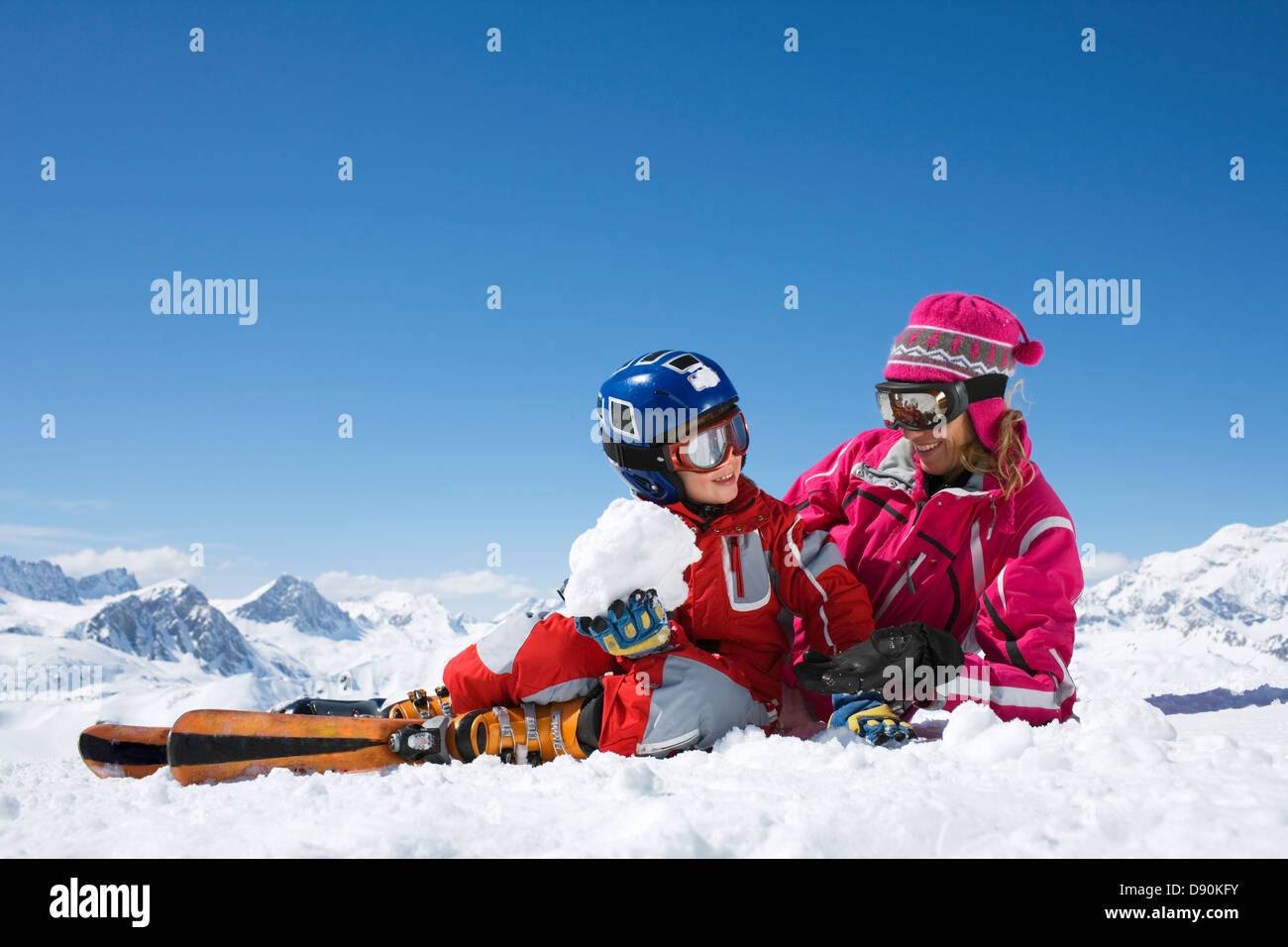 Mother and son resting on the snow Stock Photo - Alamy