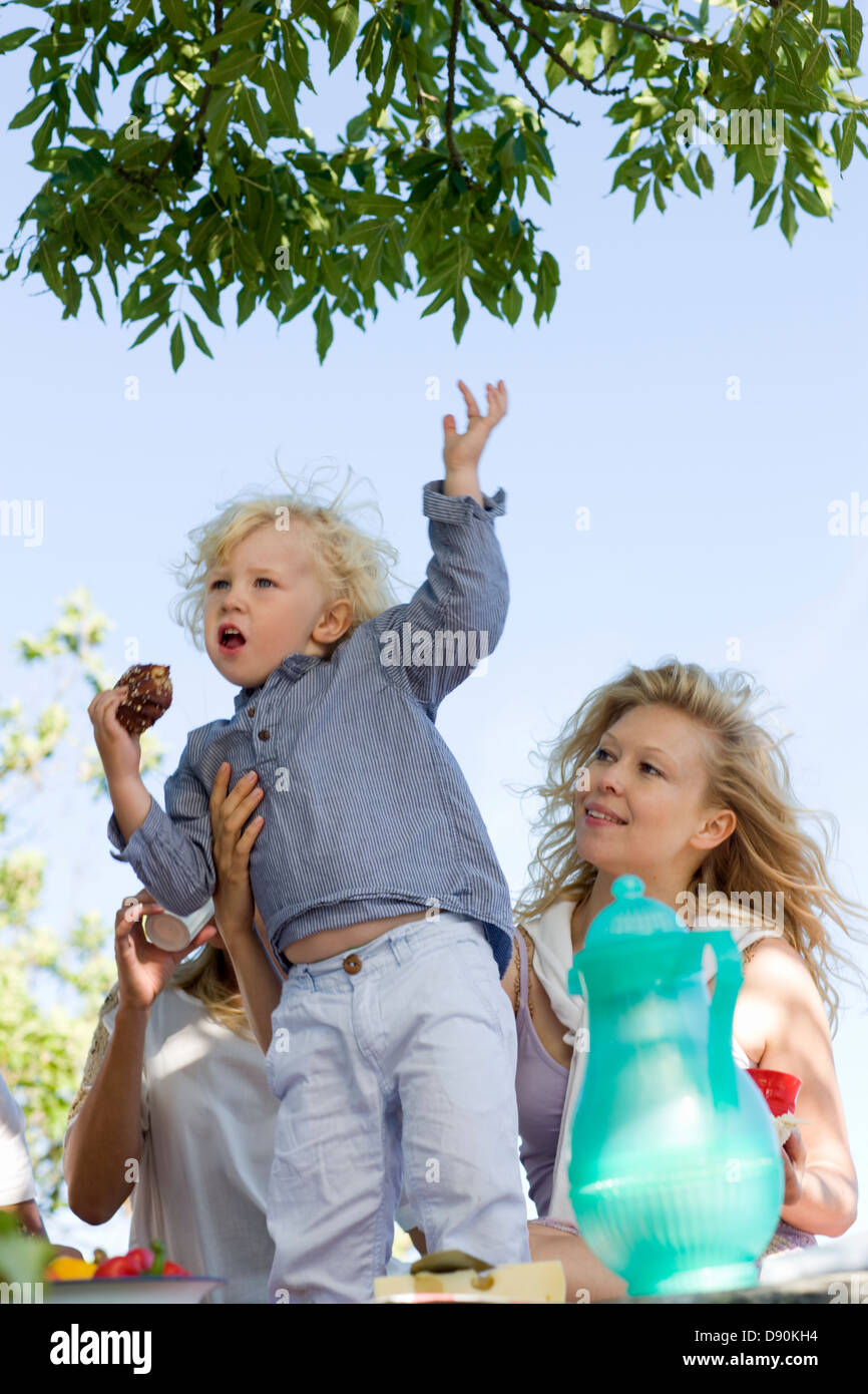 Family having picnic, boy standing with arms up Stock Photo - Alamy