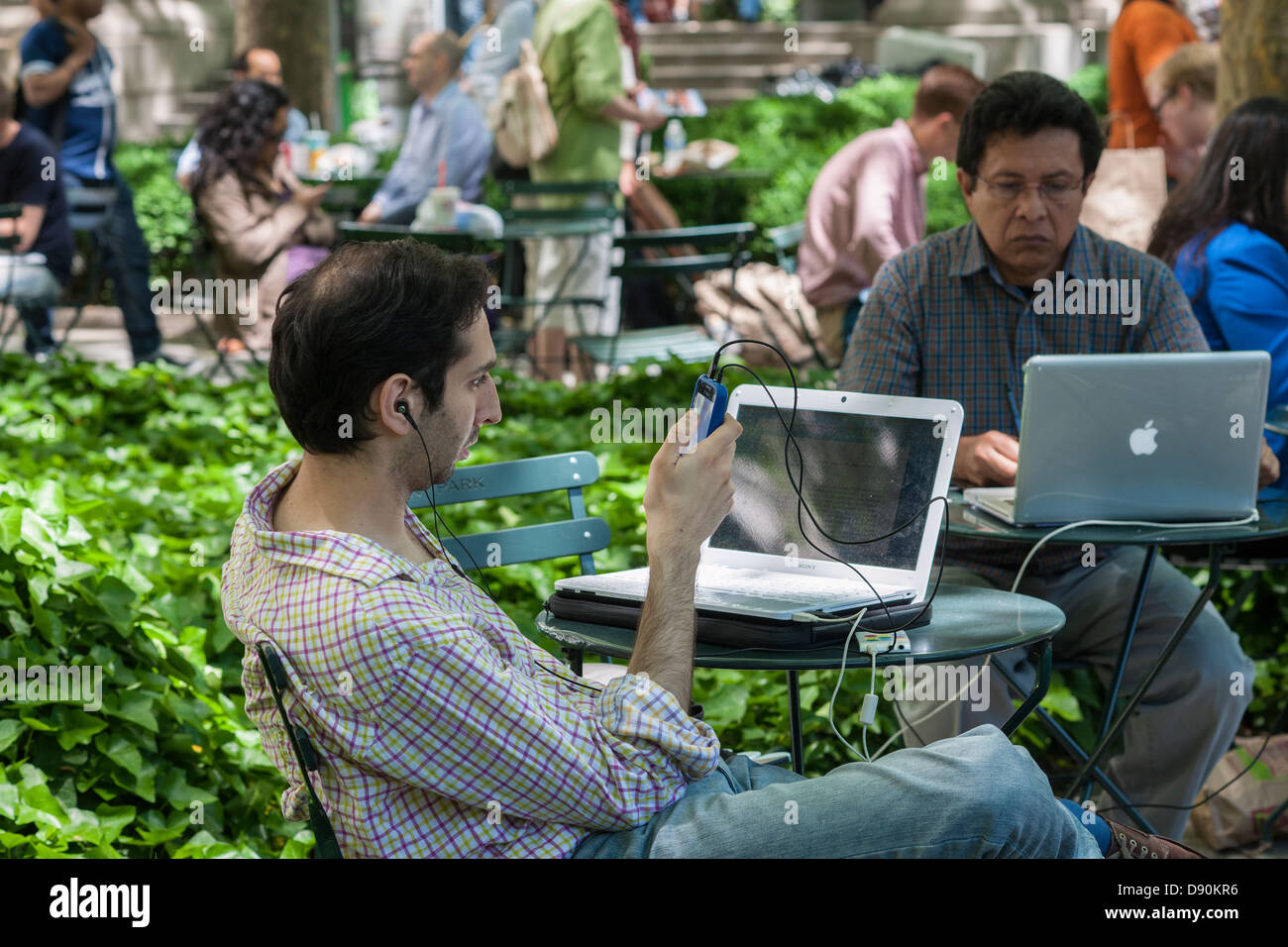 Visitors to Bryant Park in New York use their laptop computers on ...