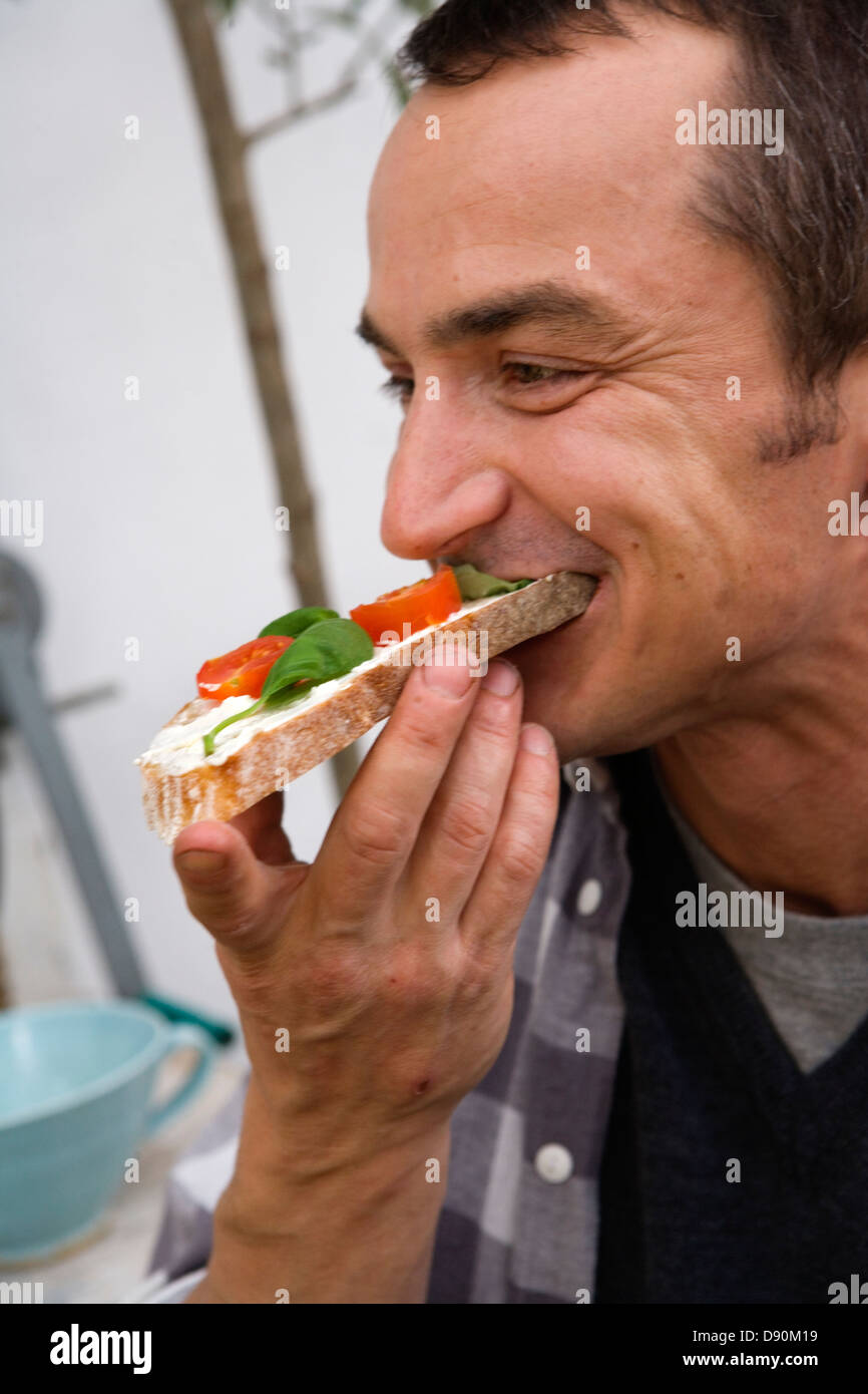 A man eating a sandwich Stock Photo - Alamy