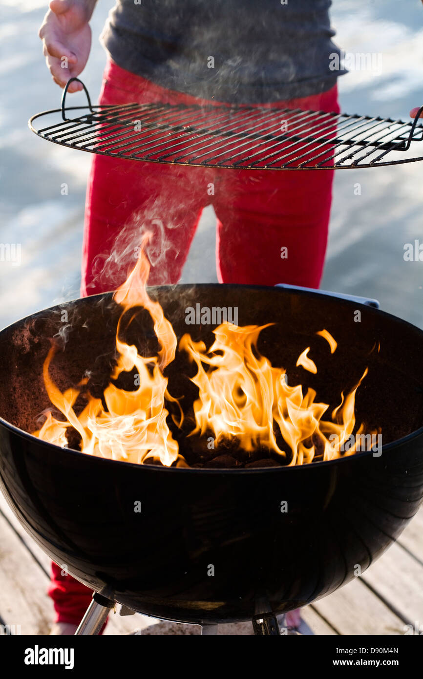 Man holding barbecue fire on hi-res stock photography and images - Alamy