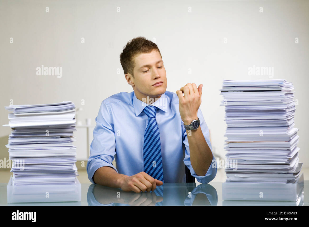 A man with a pile of paper Stock Photo - Alamy