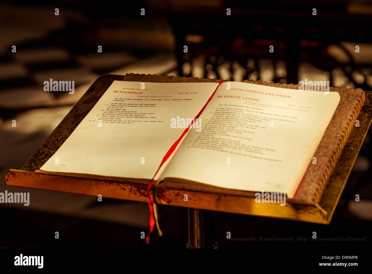 Open Bible book on Gospel (Evangelie) page in church in Bruges, Belgium ...
