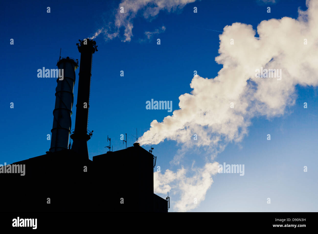 Smokestacks releasing smoke Stock Photo - Alamy