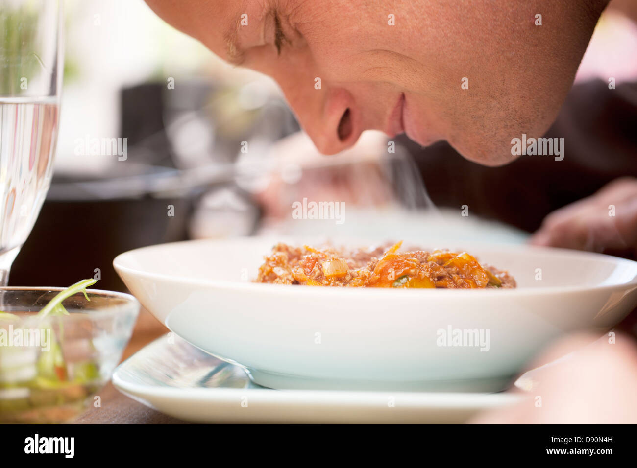 Man smelling food Stock Photo - Alamy