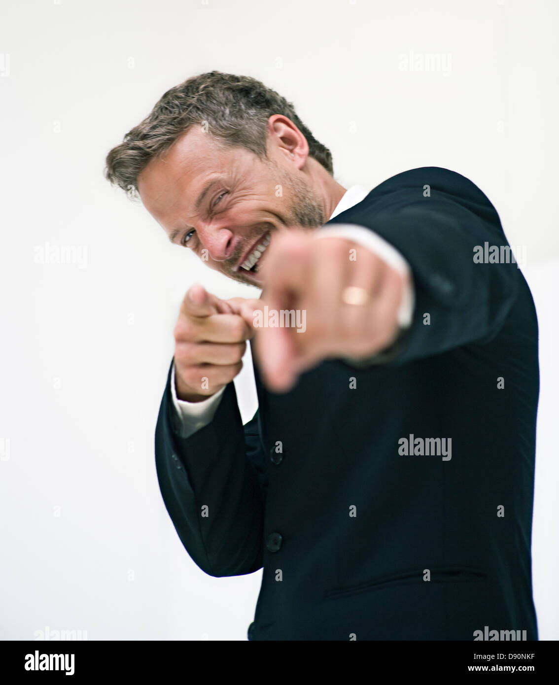 Studio portrait of businessman pointing Stock Photo - Alamy