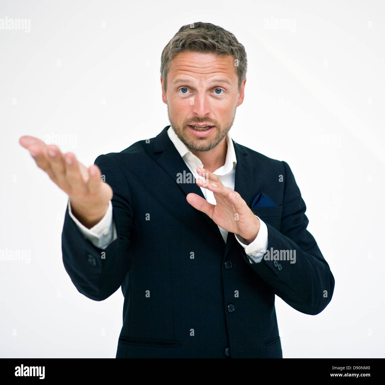 Studio portrait of businessman gesturing Stock Photo - Alamy