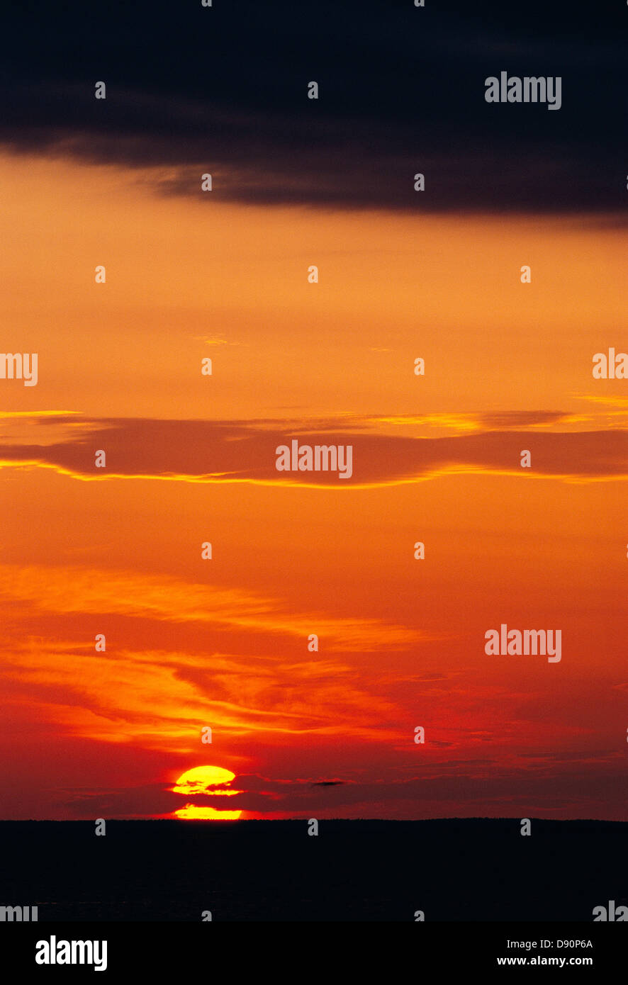 Clouds against sun at dusk Stock Photo - Alamy