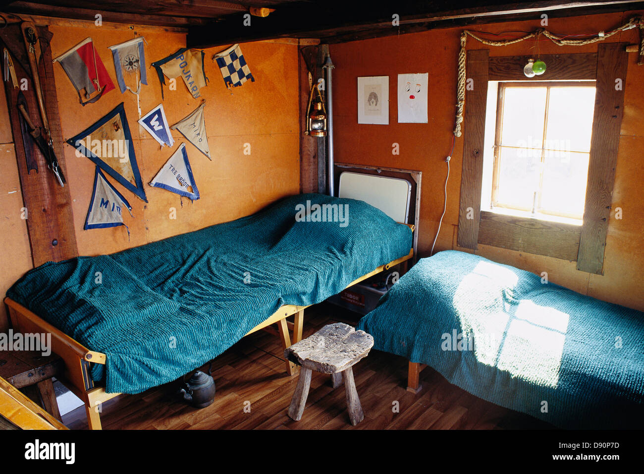 Beds in house by window Stock Photo - Alamy