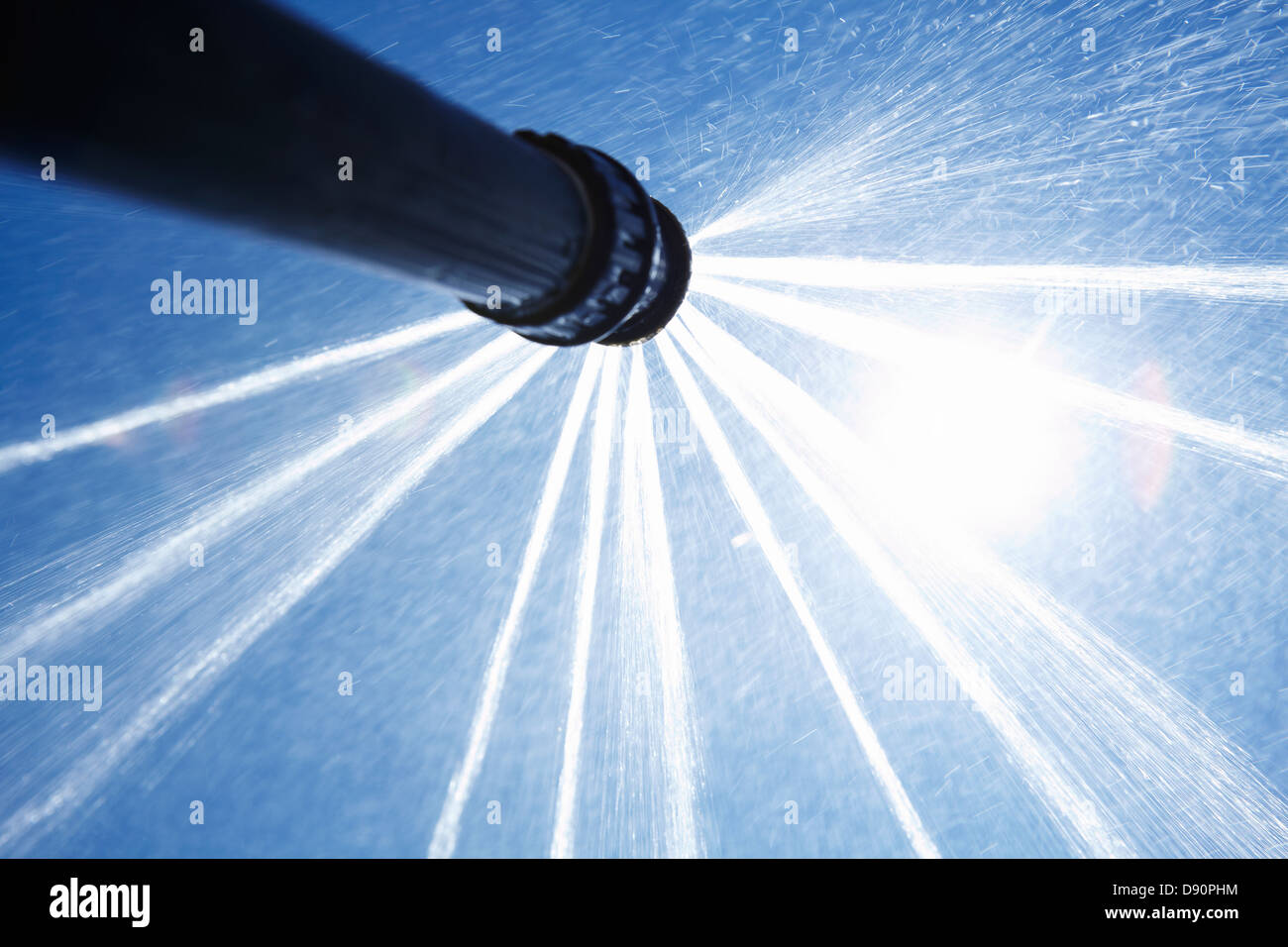 Close-up of sprinkler splashing water under sun Stock Photo - Alamy
