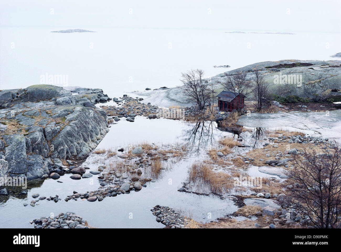 House on rocks by lake Stock Photo - Alamy