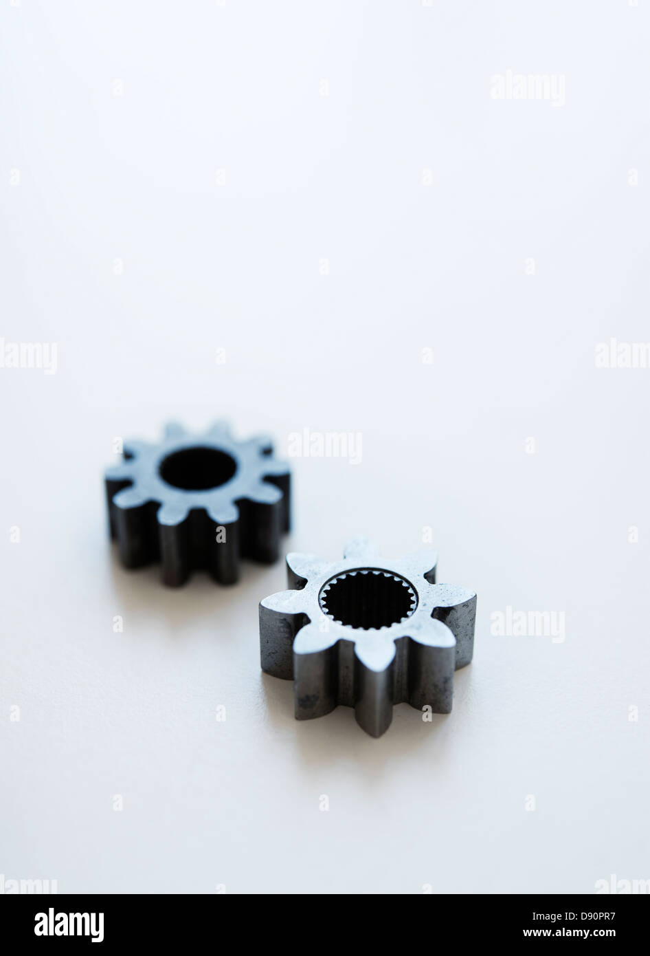 Two cogs against white background Stock Photo - Alamy