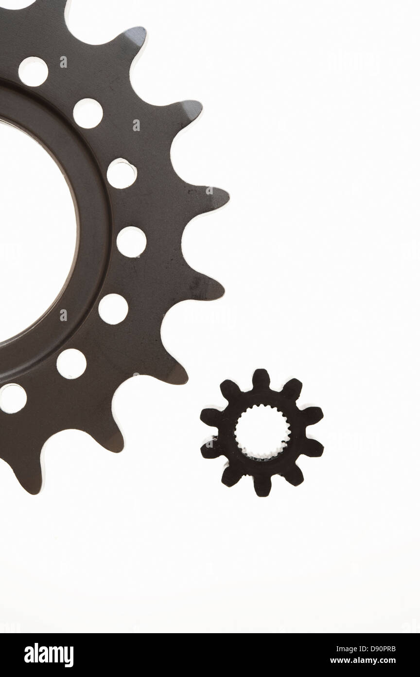 Two large and small cogs against white background Stock Photo - Alamy