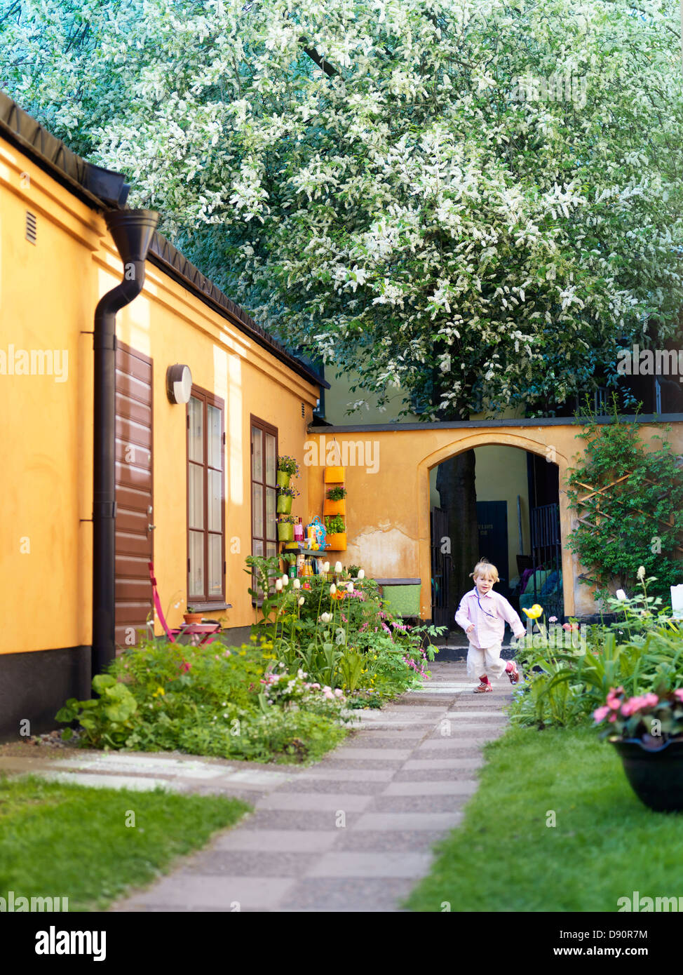 Boy running in back yard Stock Photo - Alamy