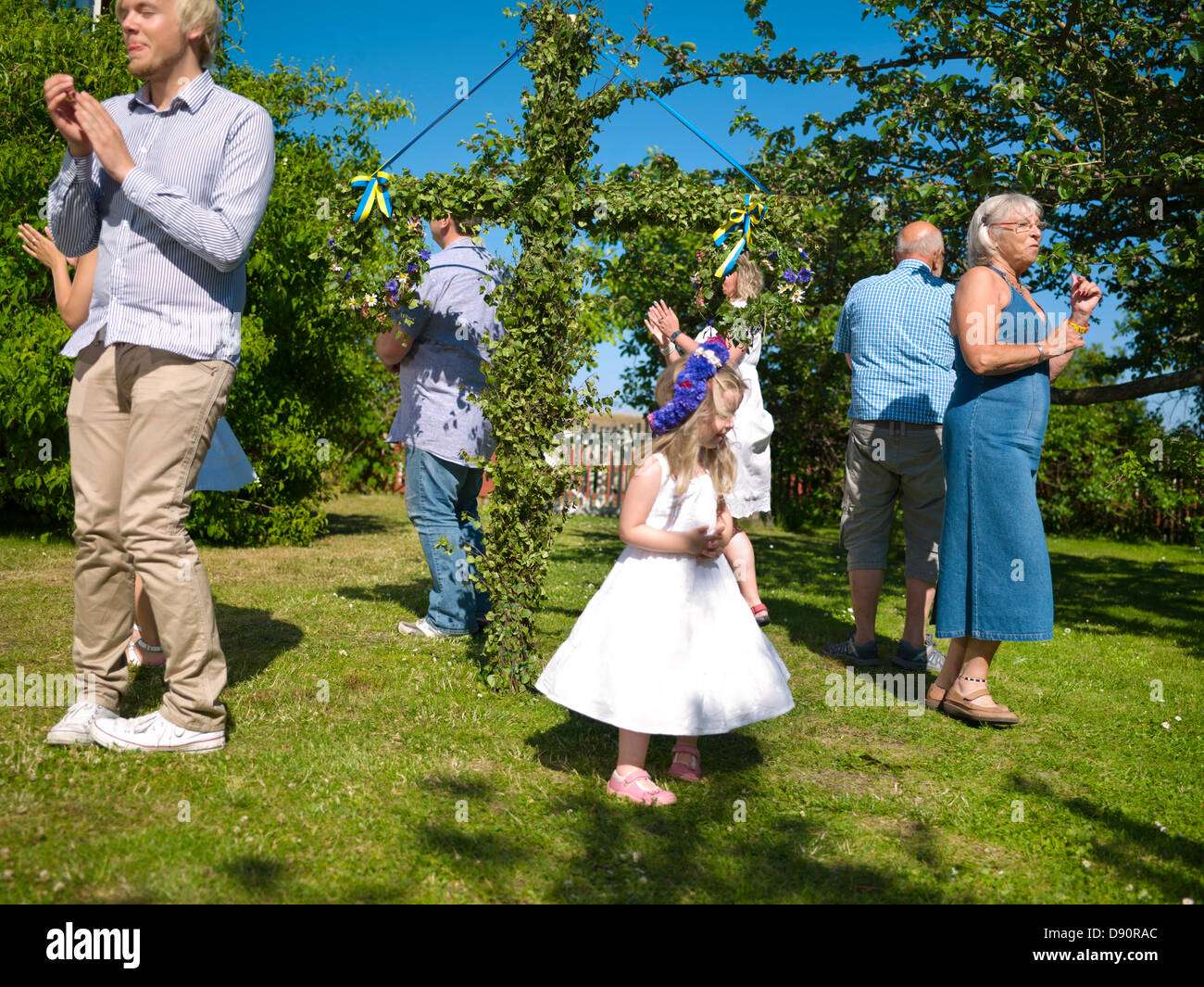 Family dancing around maypole in garden Stock Photo - Alamy