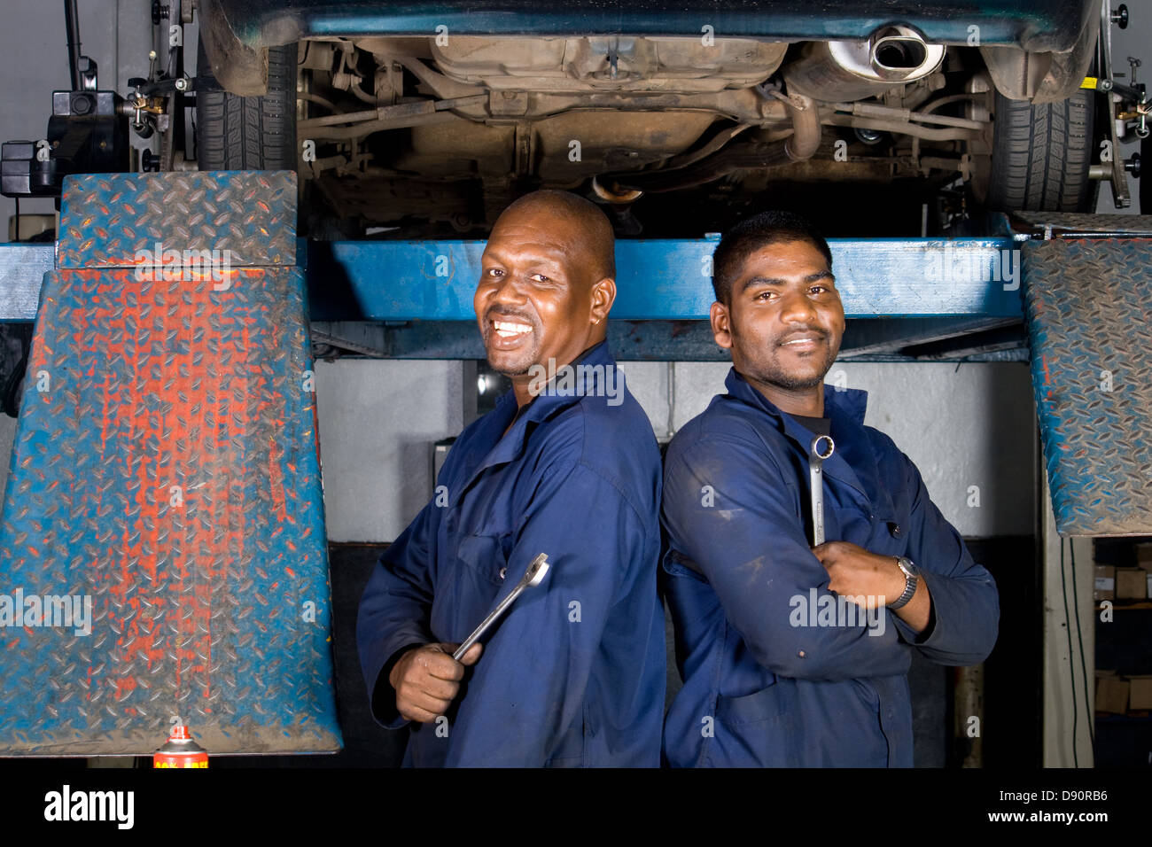 two african american mechanics inside garage Stock Photo - Alamy