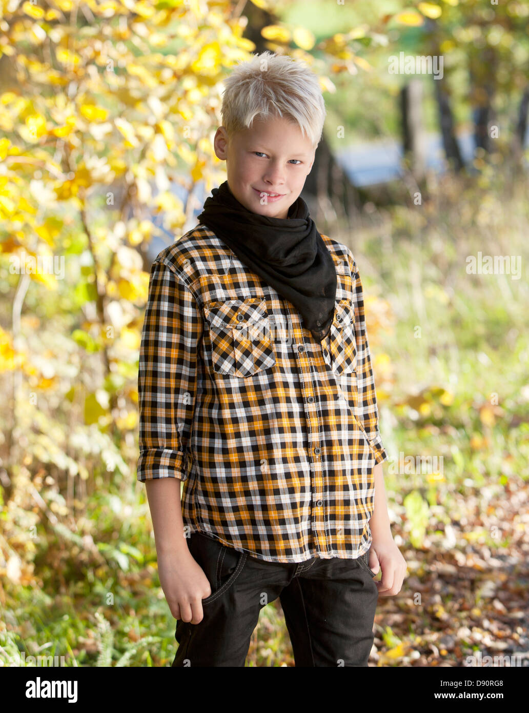 Portrait of blonde boy standing outside Stock Photo - Alamy