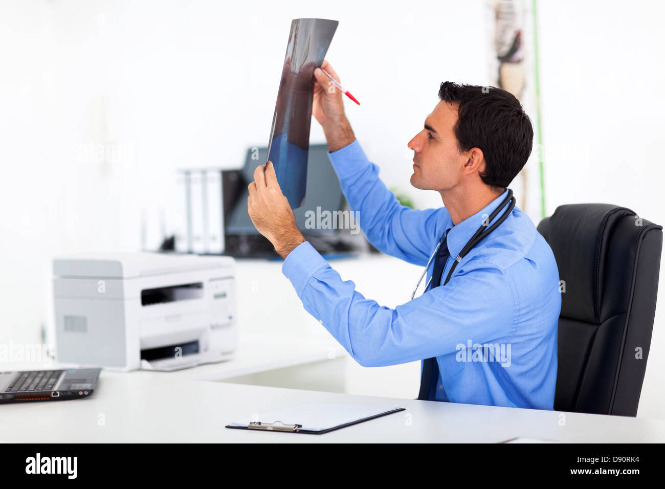 male doctor analyzing CT scan in office Stock Photo - Alamy