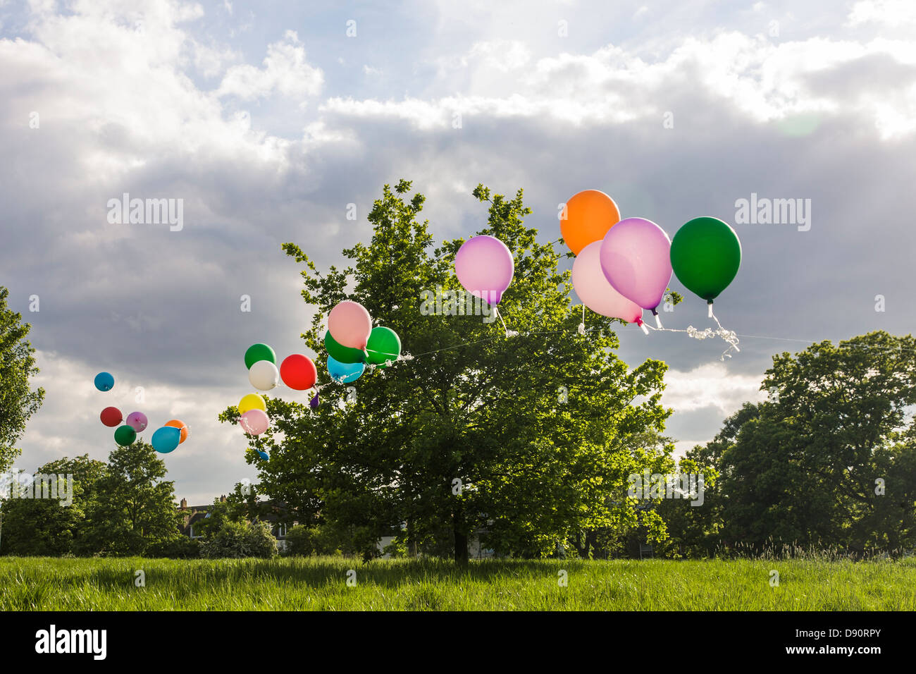 floating string of colourful balloons filled with helium Stock Photo ...