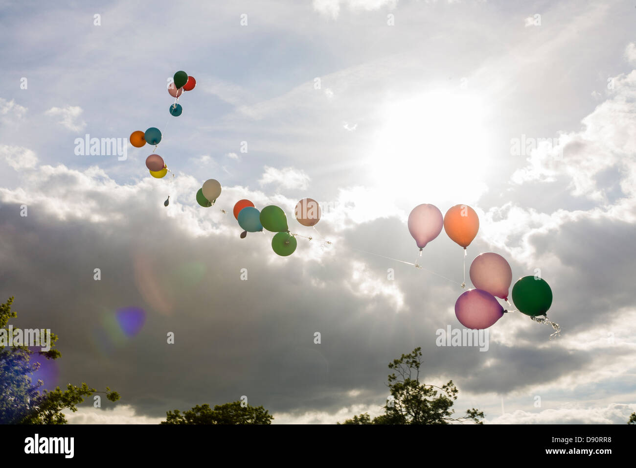 floating string of colourful balloons filled with helium Stock Photo ...