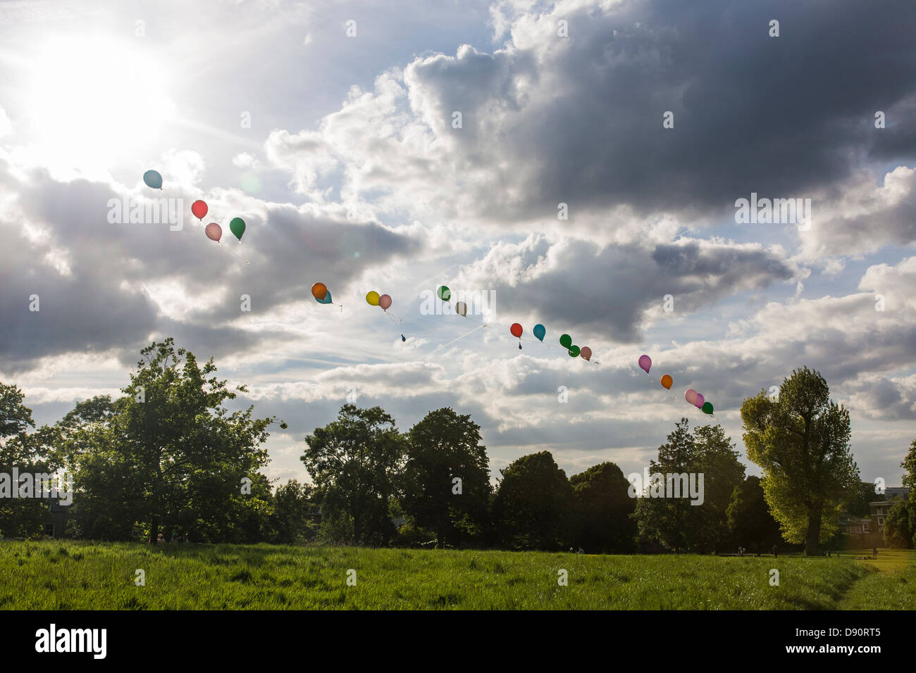 floating string of colourful balloons filled with helium Stock Photo ...
