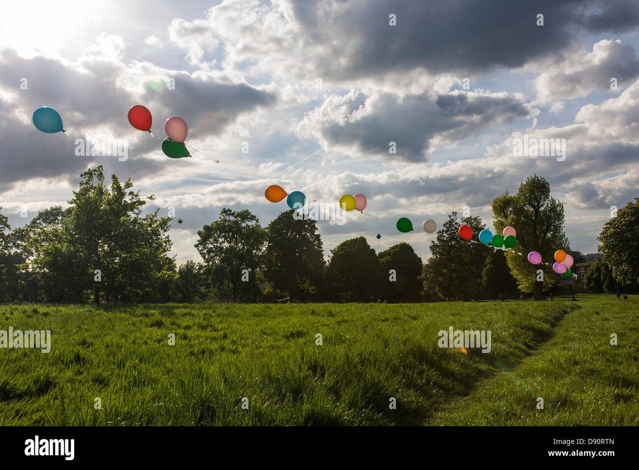 floating string of colourful balloons filled with helium Stock Photo ...