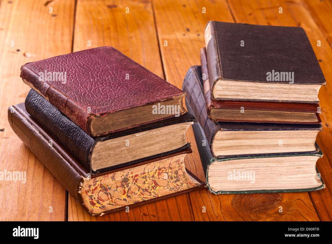 Old Books 0n Rustic Pine Table - Piles of old books on a rustic wooden ...