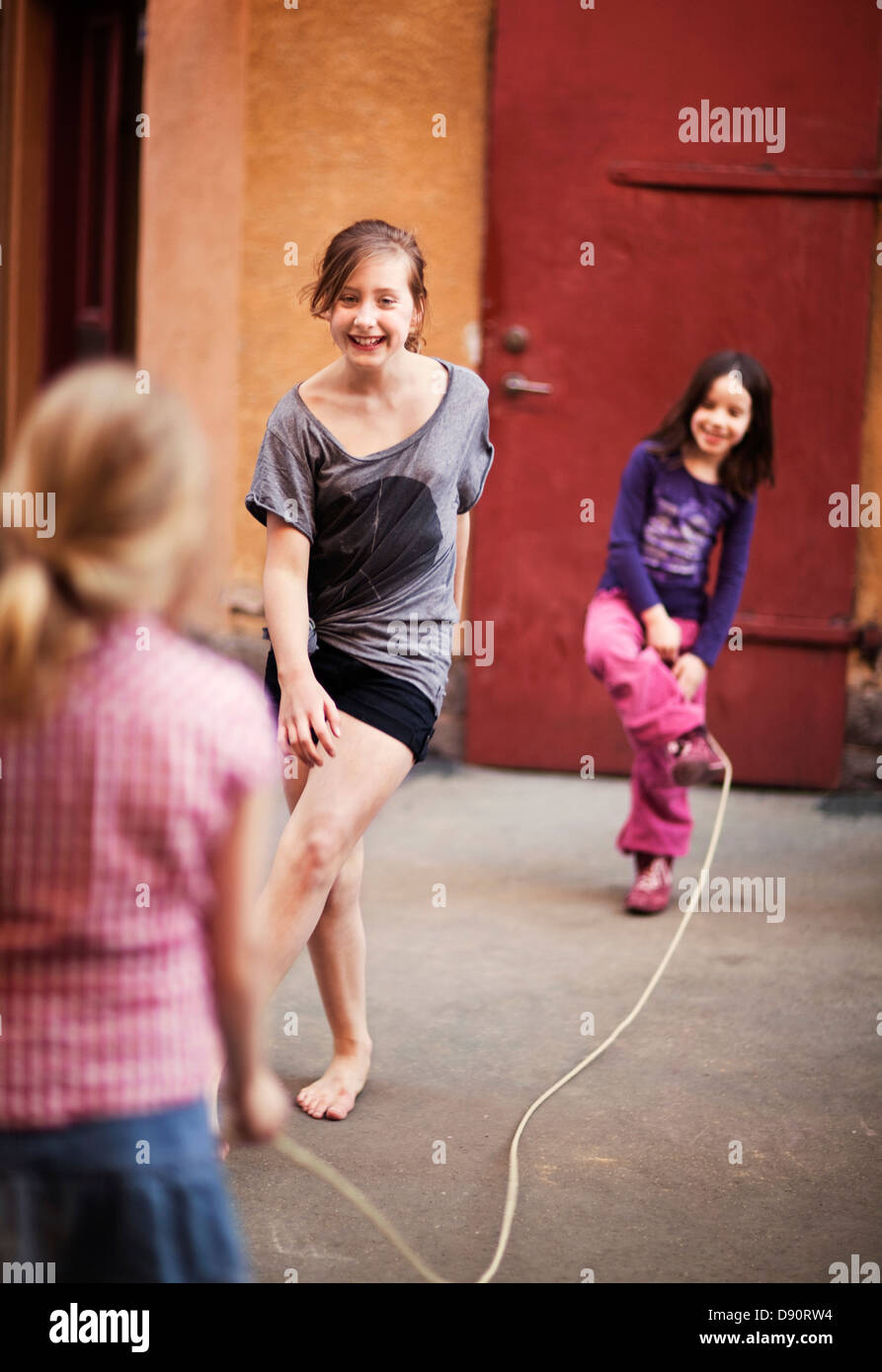 Girls skipping rope Stock Photo - Alamy