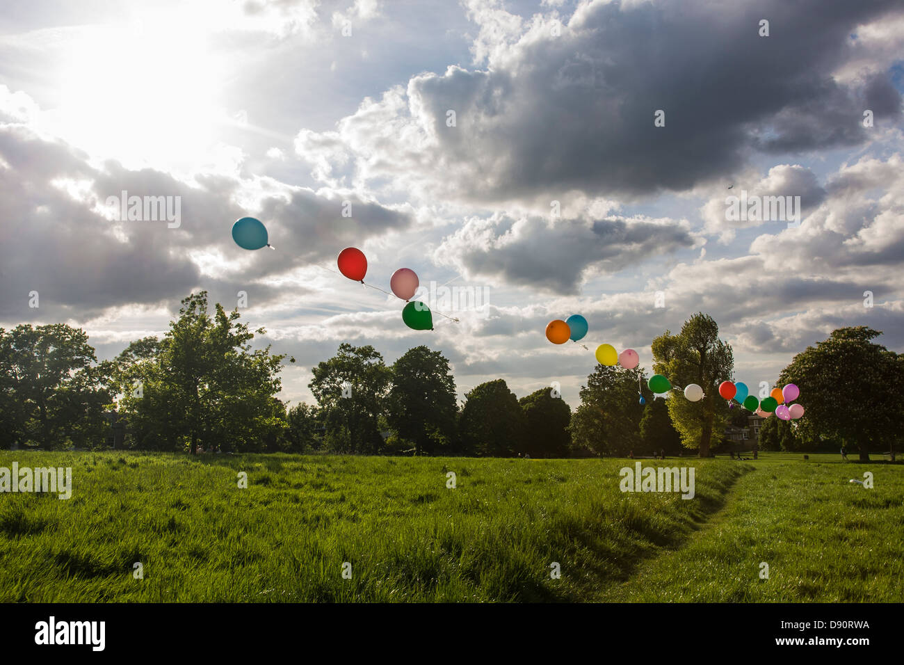 floating string of colourful balloons filled with helium Stock Photo ...