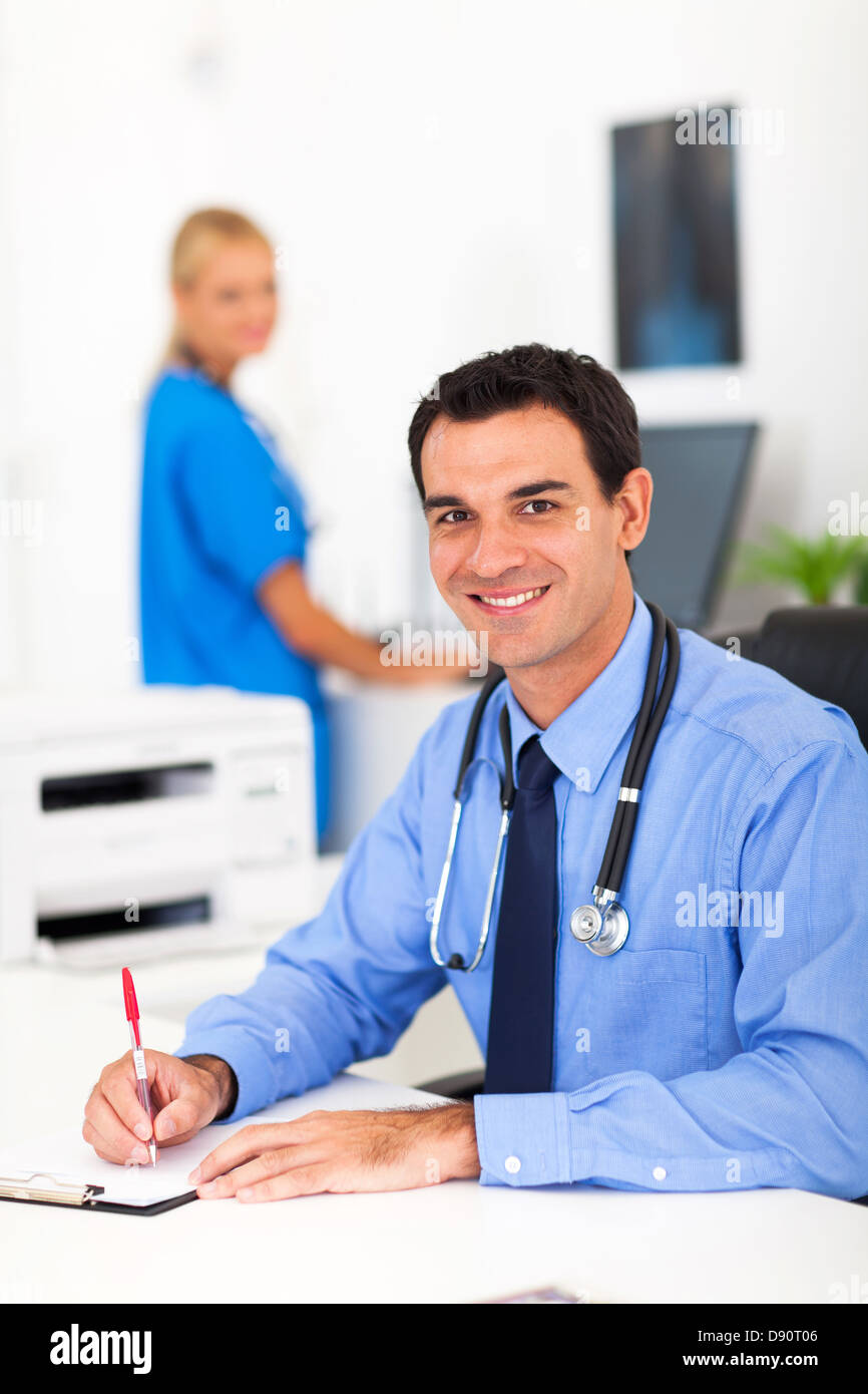 portrait of cheerful medical doctor in office with female nurse on ...