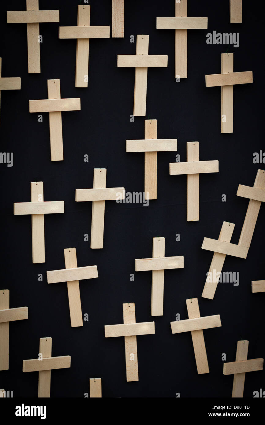 25 plain handmade wooden crosses suspended on a black canvas Stock ...