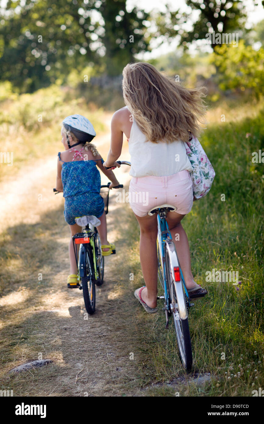 Girls cycling on path Stock Photo - Alamy