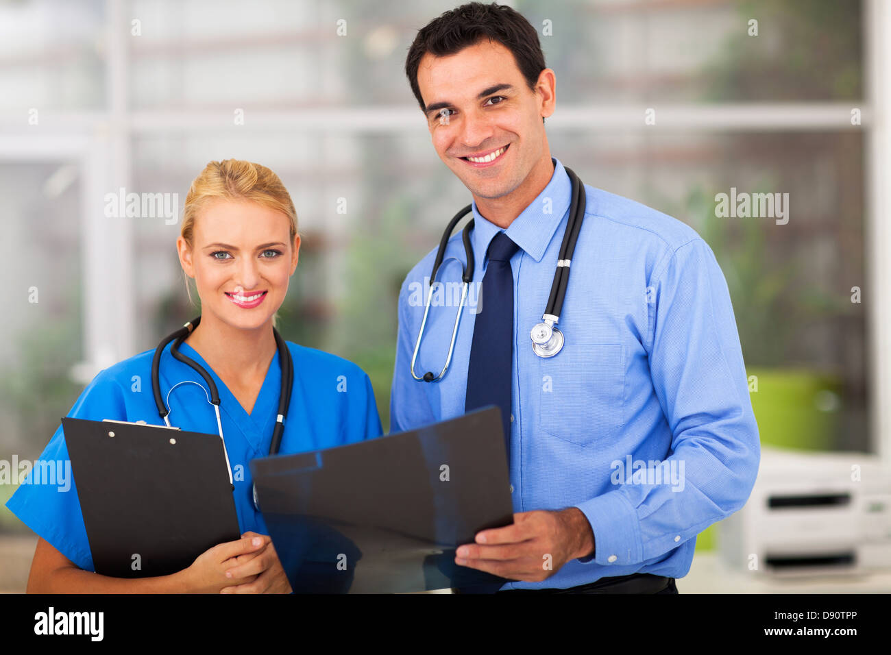 portrait of medical doctor and young female nurse in office Stock Photo ...