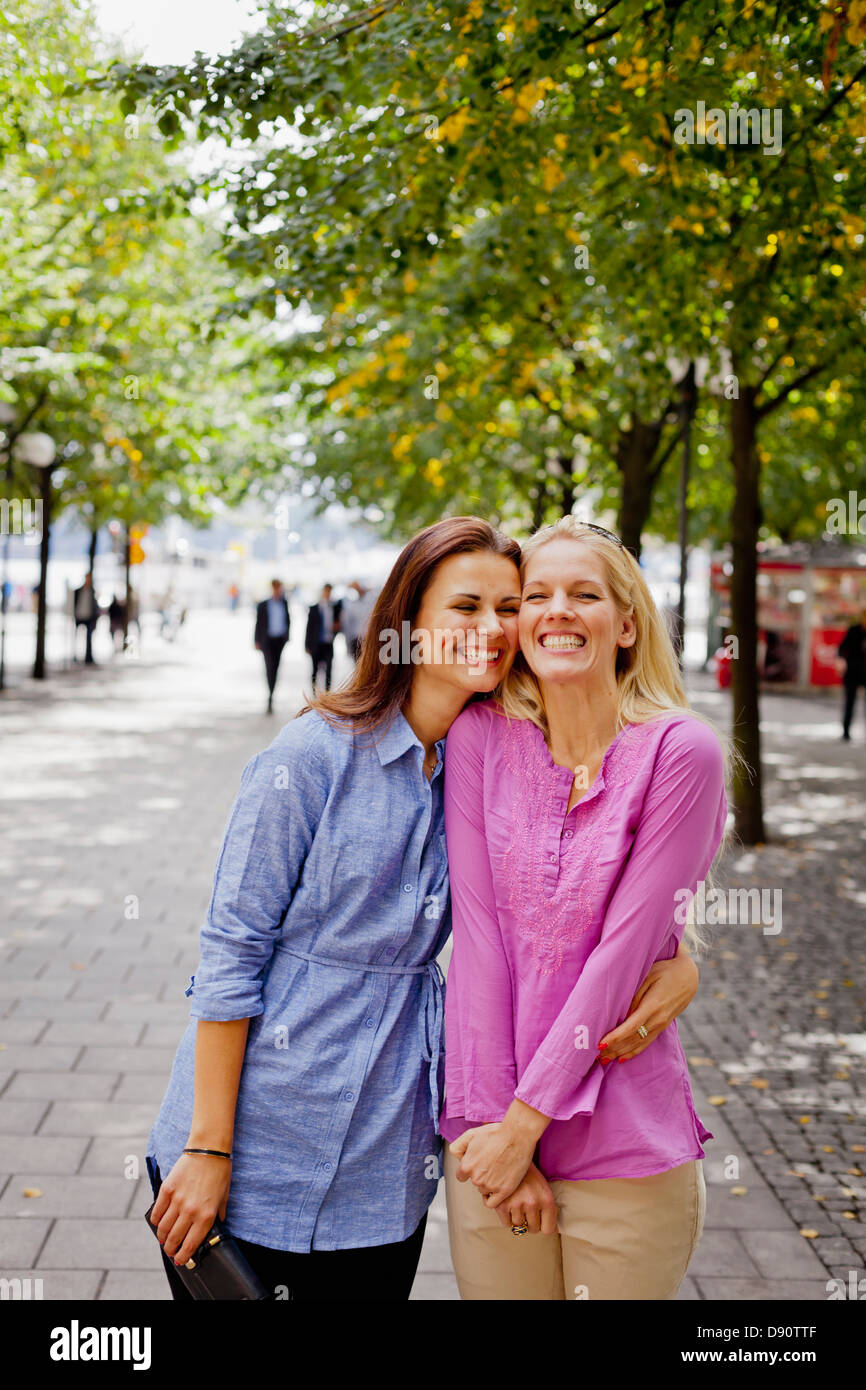 Two friends embracing in park Stock Photo - Alamy