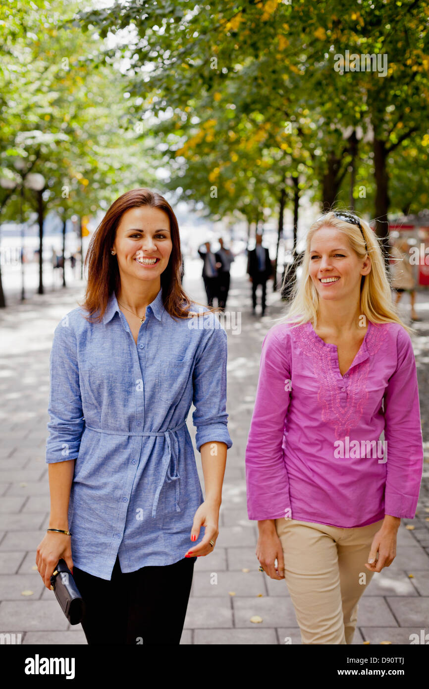 Two friends walking in park Stock Photo - Alamy